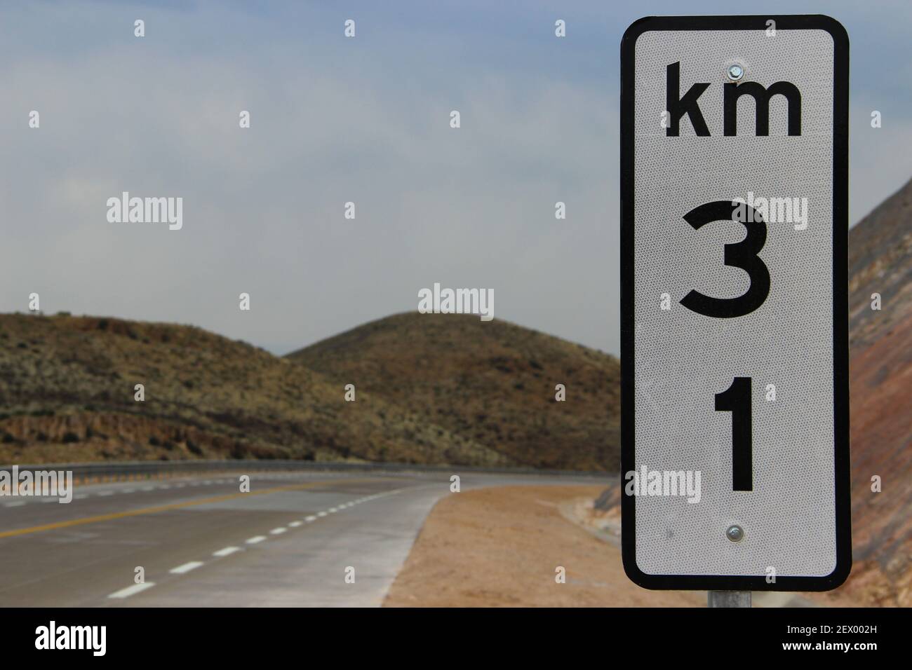 Freeway road with no cars and a kilometer mark Stock Photo - Alamy