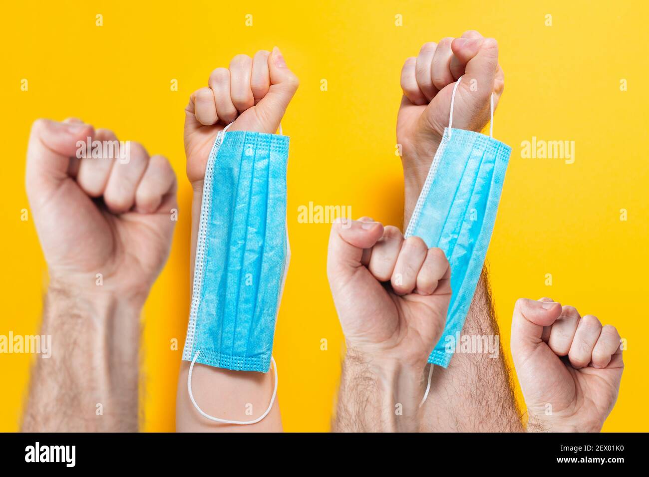 Men's hands holds medical masks in their fists and protest. Close up ...