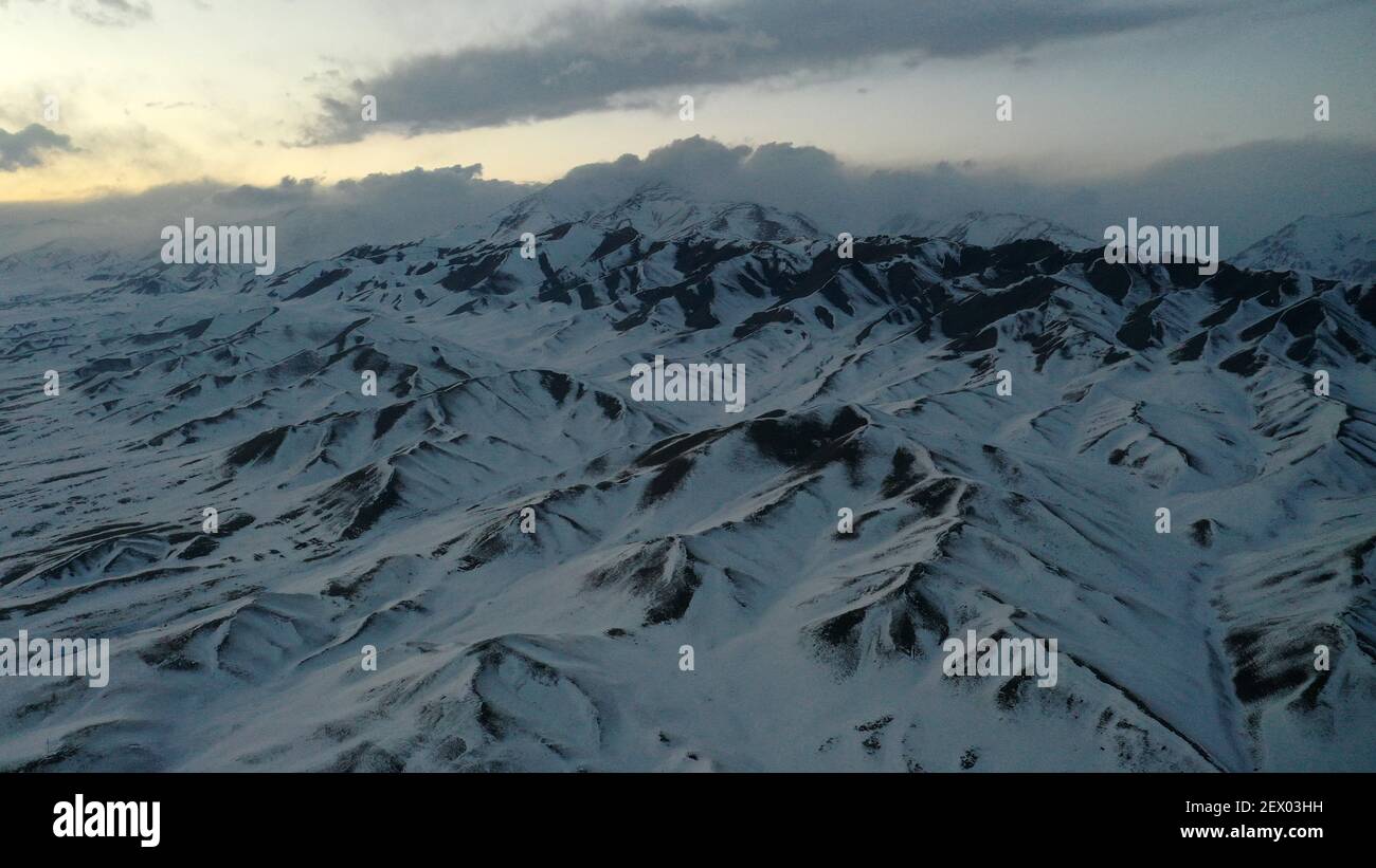 Aerial view of the snow covered Bayanbulak plateau during early spring ...