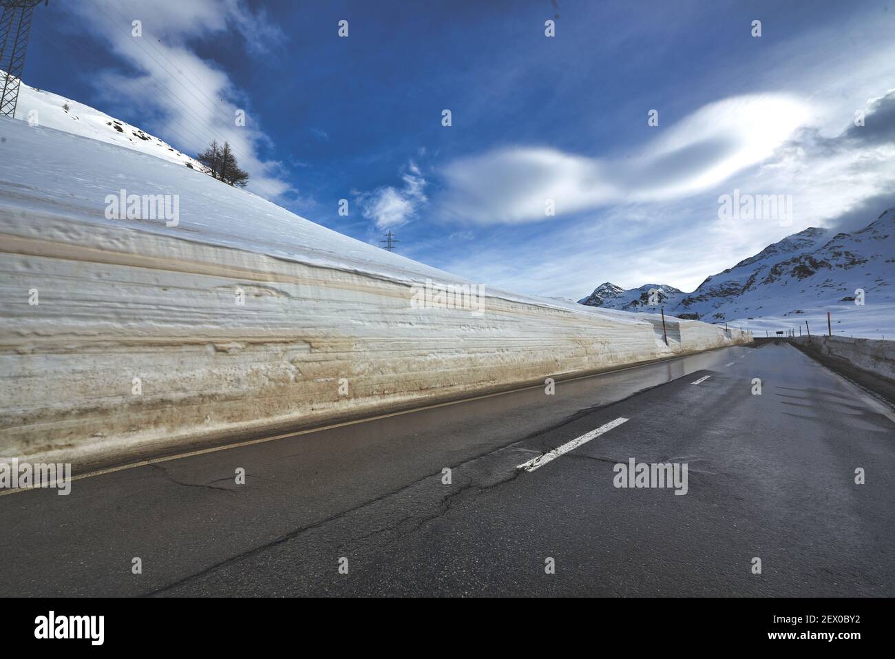Alpine pass route with lots of snow at the edges Stock Photo - Alamy