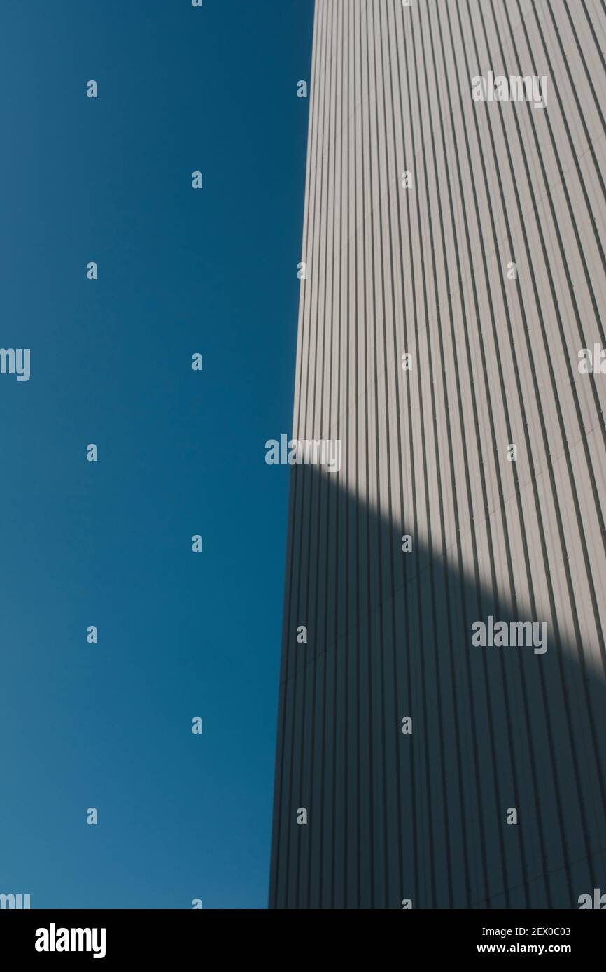 A low angle of a gray beautiful and futuristic skyscraper against the ...