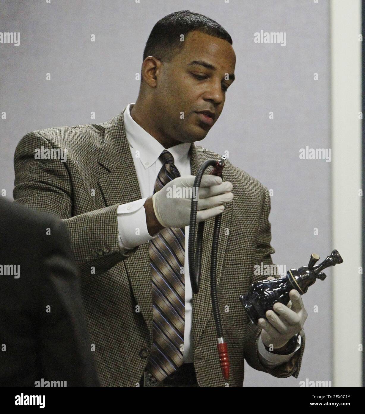 Texas Ranger David Armstrong holds a bong, part of the evidence seized ...