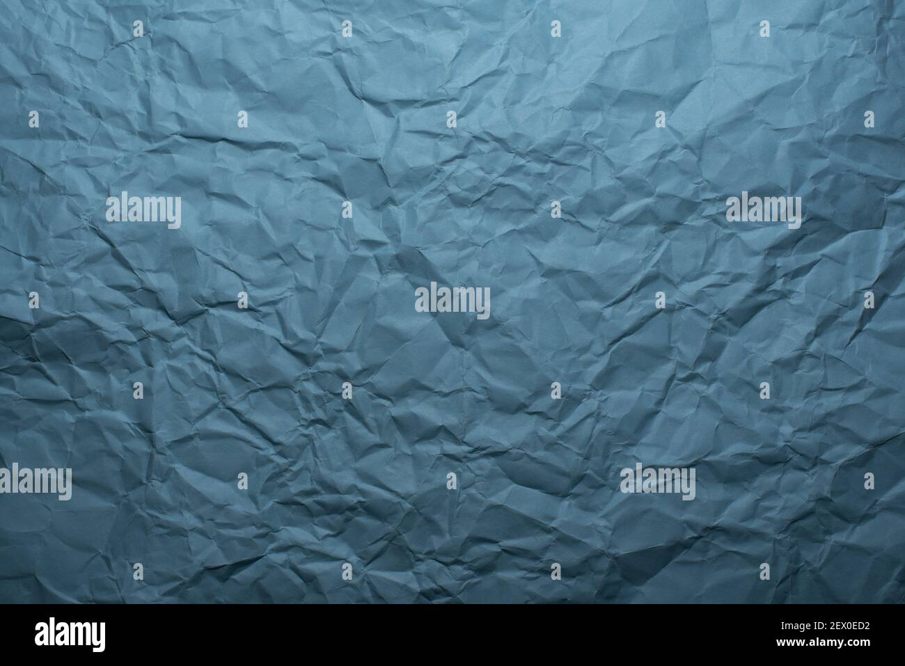 A background or wallpaper with crumpled blue paper textures Stock Photo ...