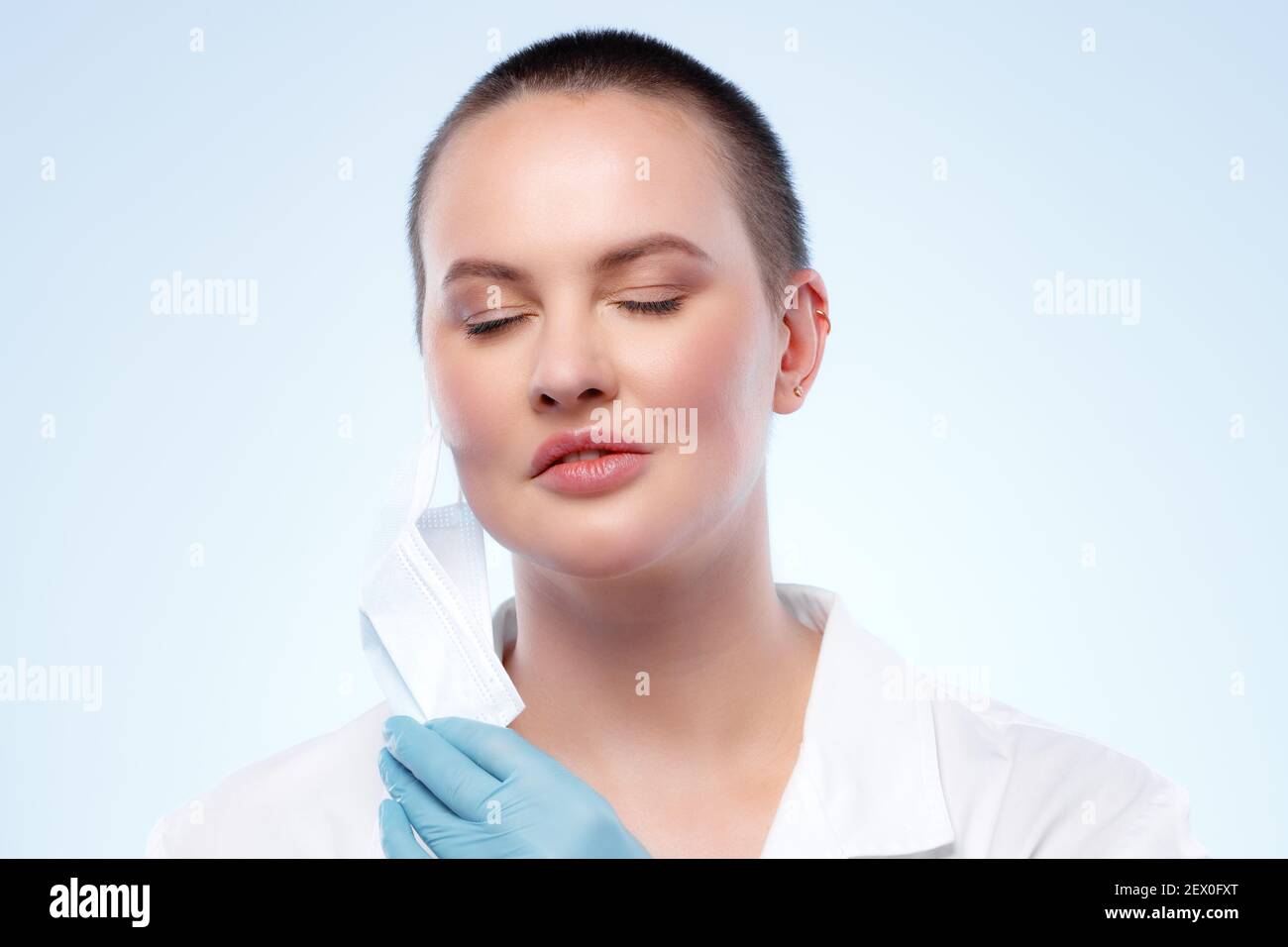 Young woman taking off medical hi-res stock photography and images - Alamy
