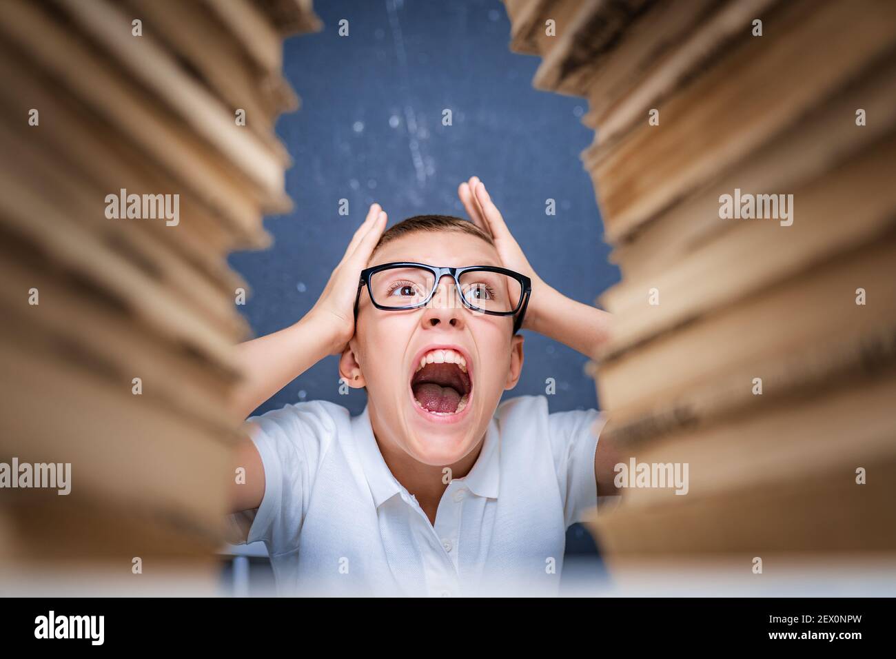 Young boy in stress getting crazy while studying and doing homework in ...