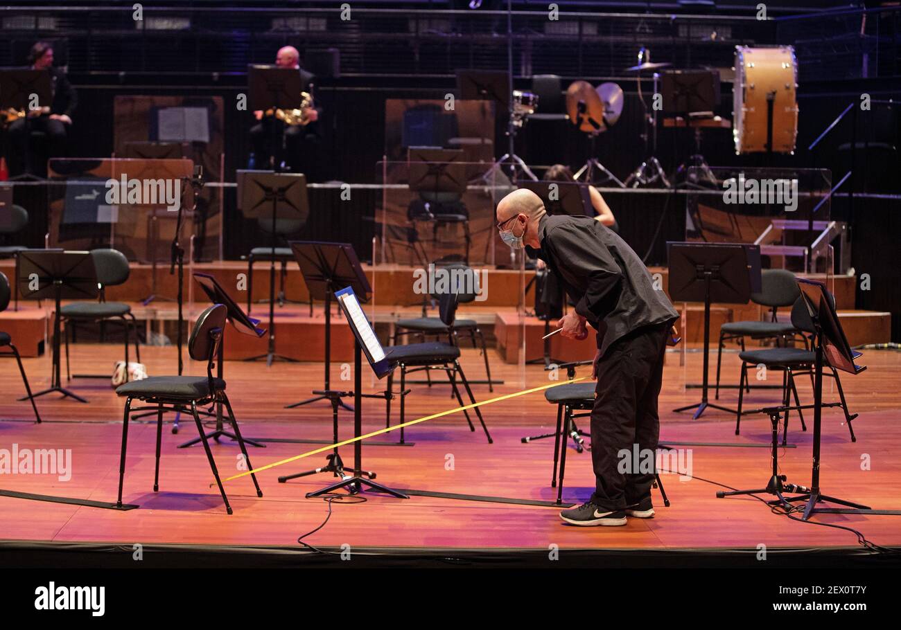 The stage manager measures the gap between chairs on stage before a ...