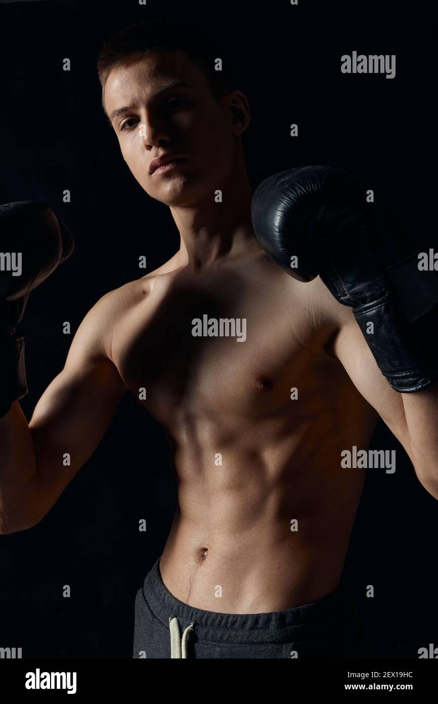 boxer in black gloves on a dark background inflated torso bodybuilder ...