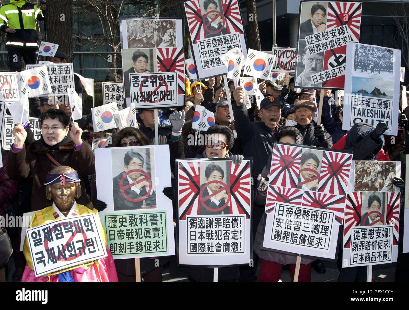 South Korean protesters hold portraits of Japanese Prime Minister ...