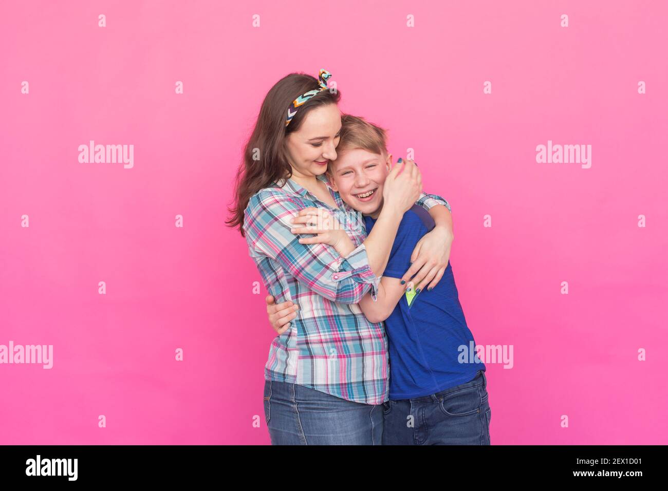 Family portrait sister and teenager brother in pink studio Stock Photo ...