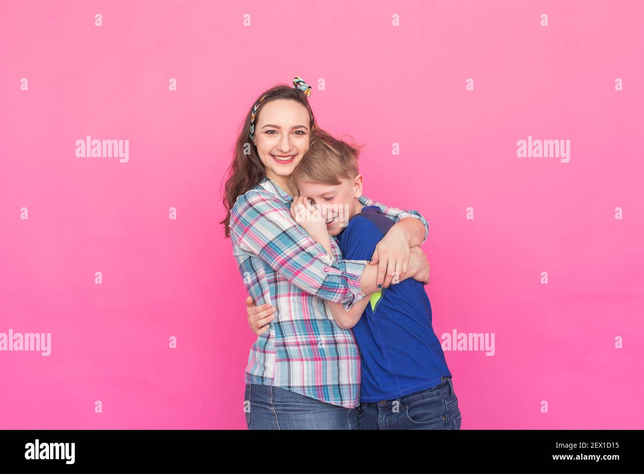 Family portrait sister and teenager brother in pink studio Stock Photo ...