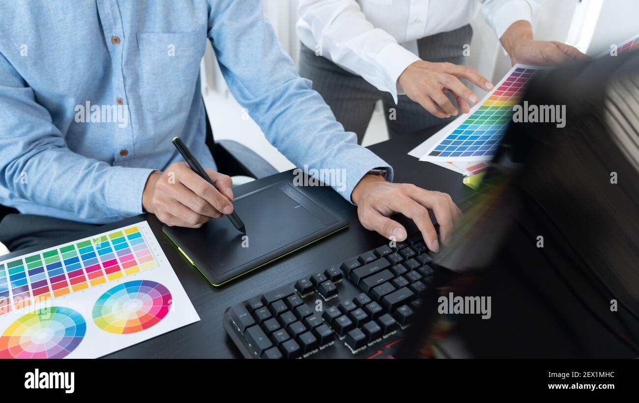 Graphic designer or creative working together coloring using graphics ...