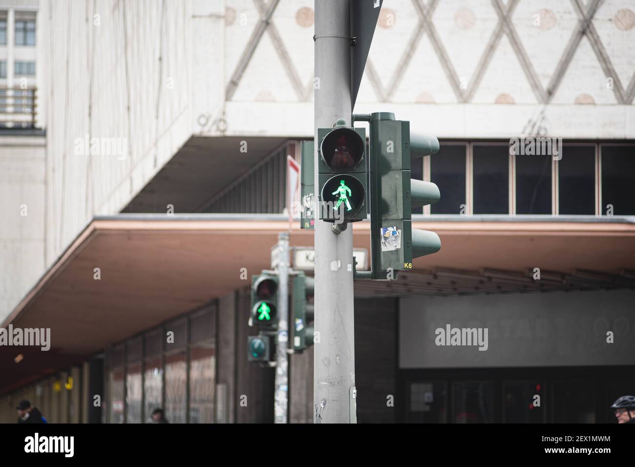 An urban city street with a green light for two traffic lights against ...