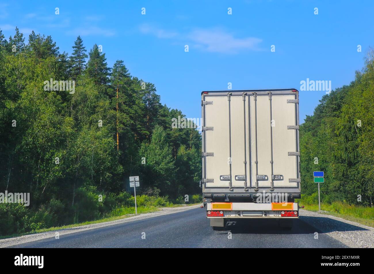 white truck transports freight on country highway Stock Photo - Alamy