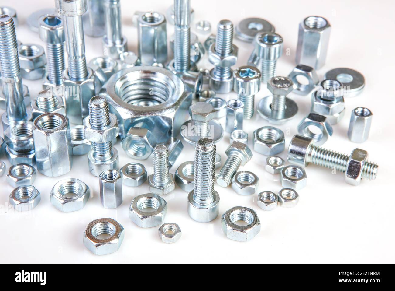chromeplated bolts and nuts on white background Stock Photo - Alamy