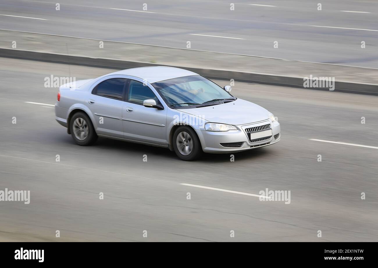 modern car driving on city street Stock Photo - Alamy