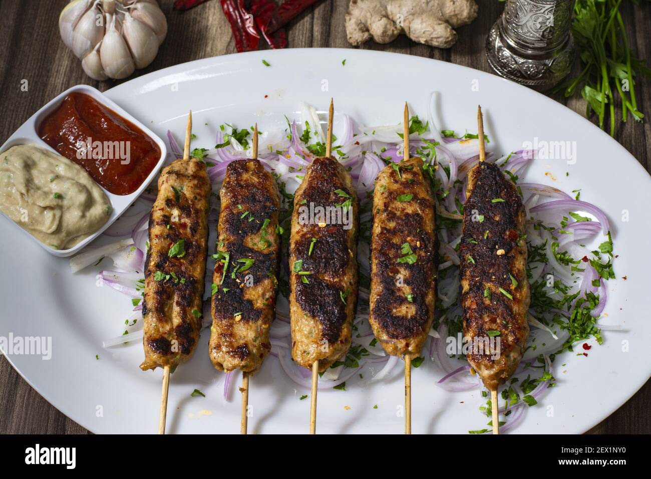 Homemade appetizing chicken kababs with skewers served on an oval plate ...