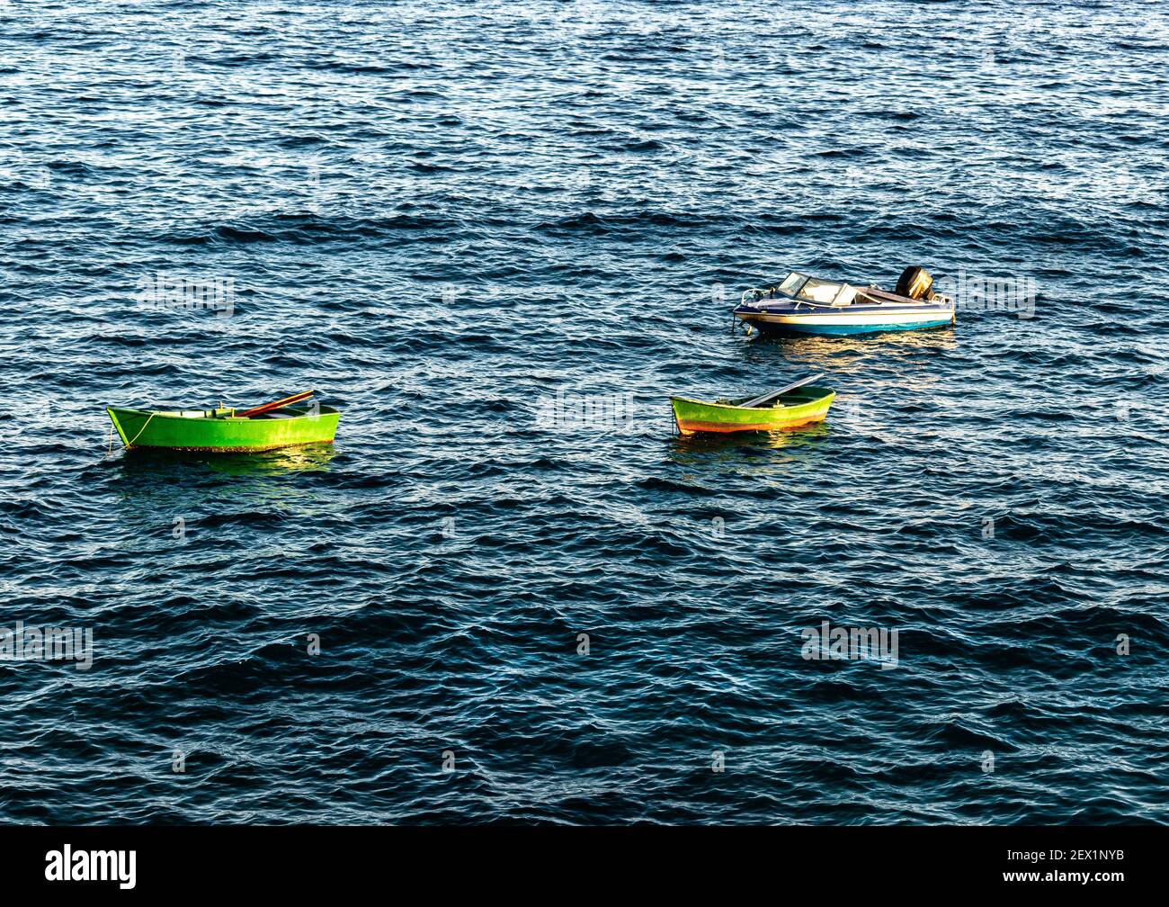 An aerial view of three empty boats on the rough sea Stock Photo - Alamy
