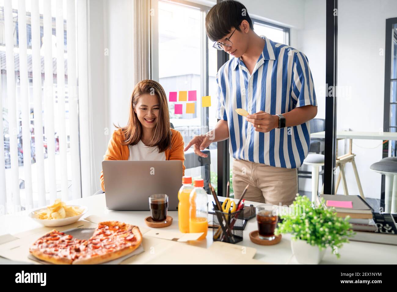 Happy business team workers talking about project and sharing meal ...