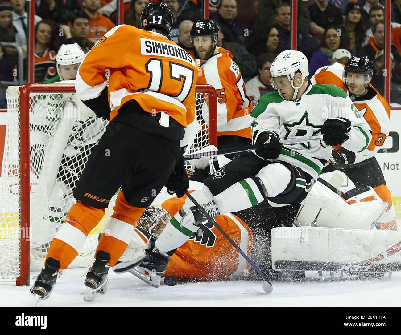 Philadelphia Flyers goalie Steve Mason stops the puck with teammate ...