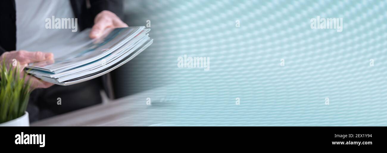 Male hands holding a stack of magazines; panoramic banner Stock Photo ...