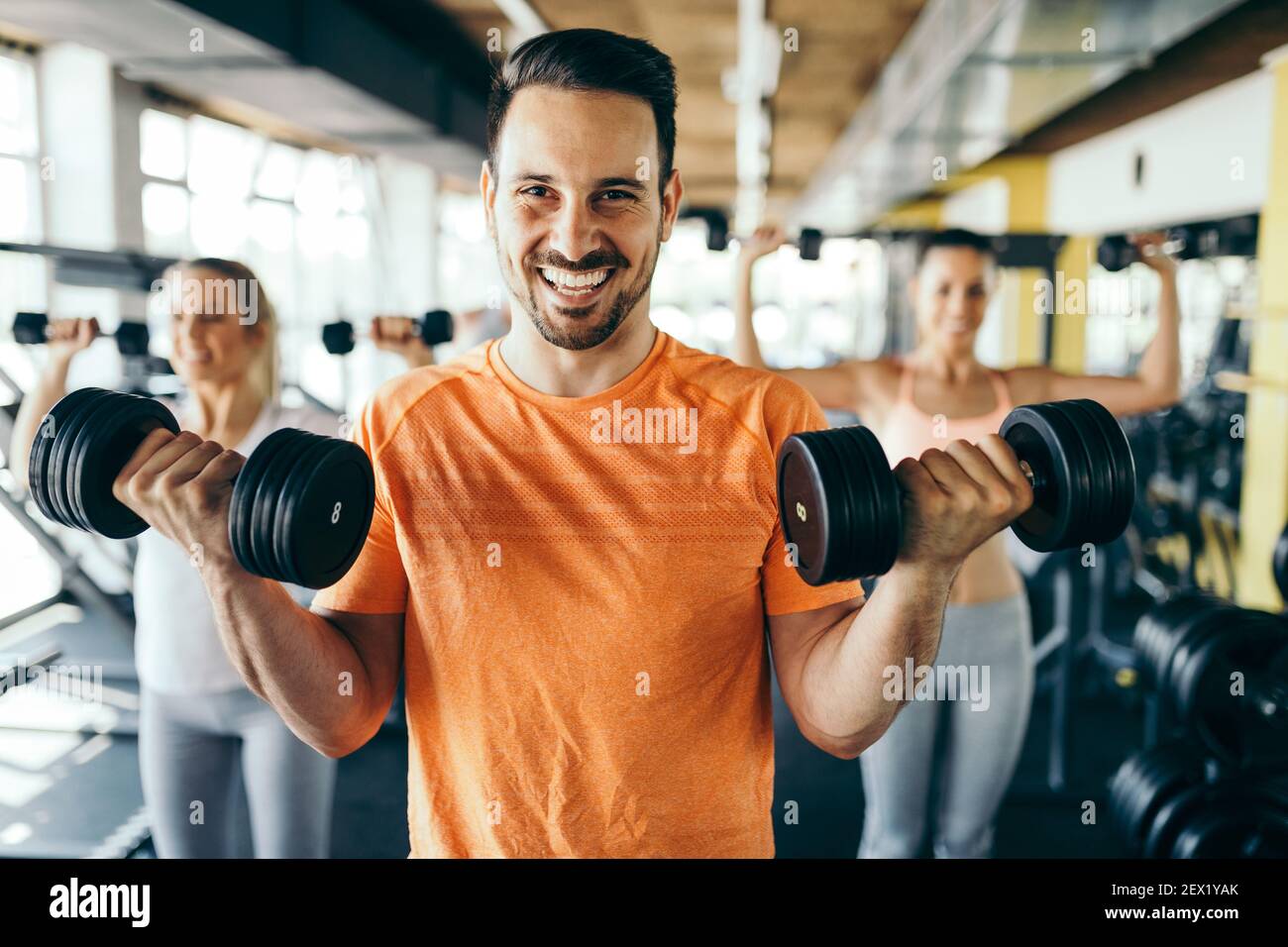 Group of fit young people exercising at the gym Stock Photo - Alamy