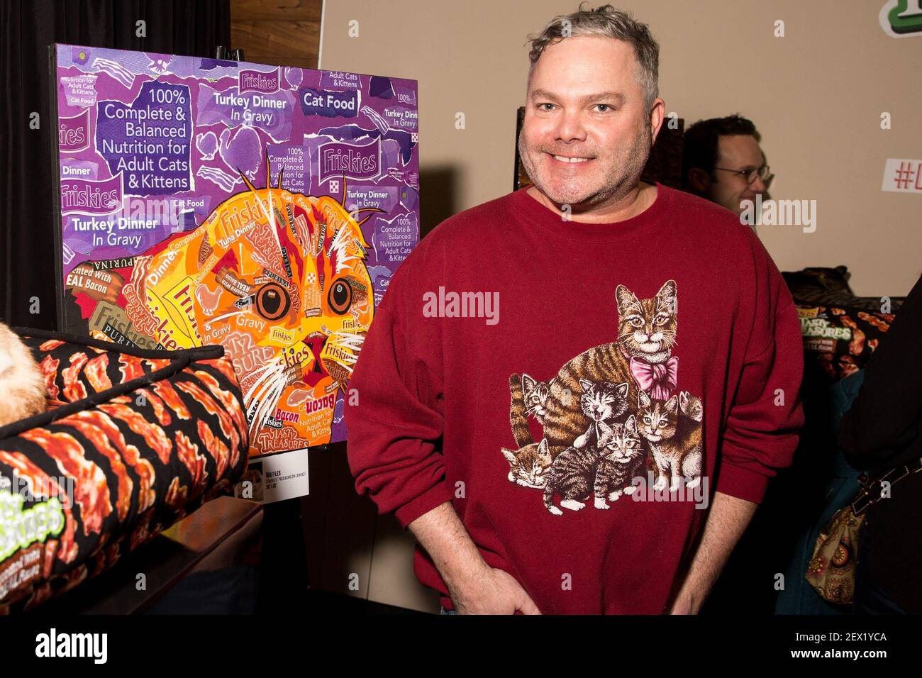 Artist Jason Mecier stands with his mosaic portrait of Waffles the Cat ...
