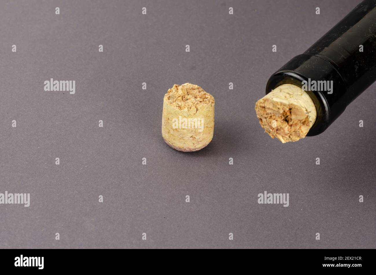 Wine bottle with broken cork on gray background. A bottle of red wine ...