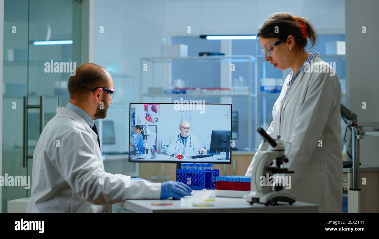 Team of scientist advicing with professional doctor on video call ...