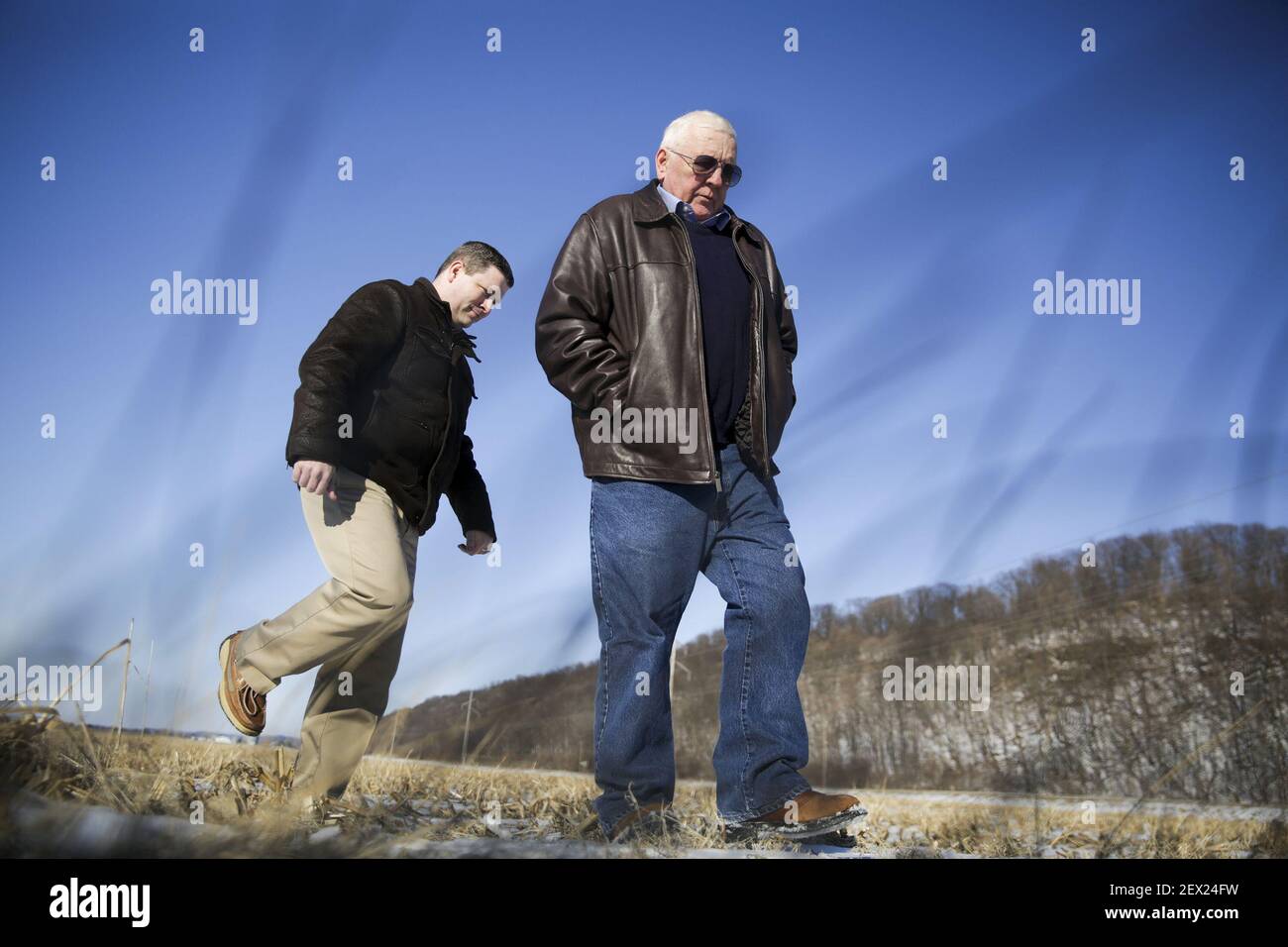 From left, John Powell and his father Jim Powell walk at Hartwell Ranch ...
