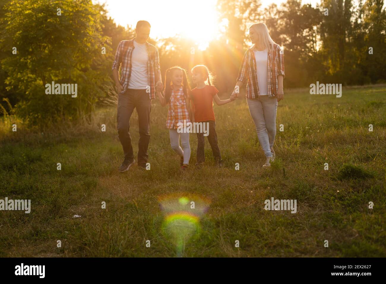 Happy family: mother father and child daughter on nature on sunset ...