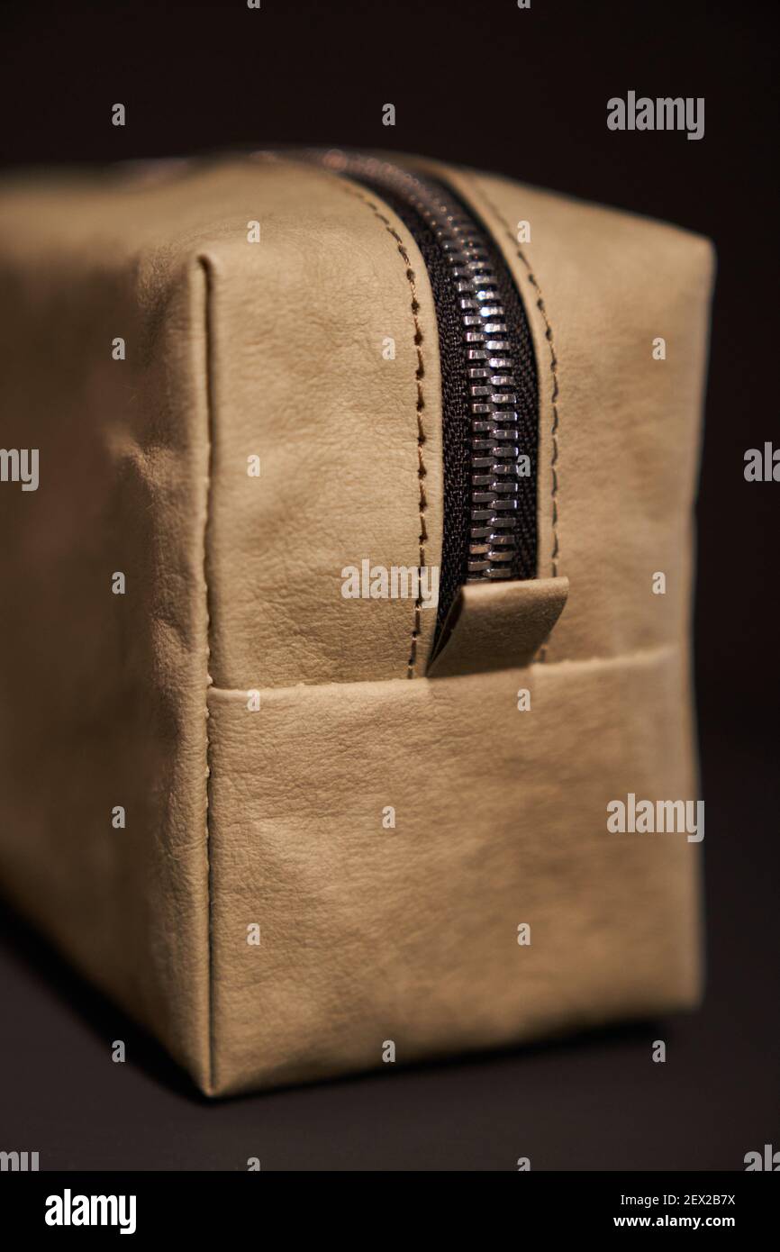 Zero waste reusable eco paper made travel cosmetic bag on a black ...