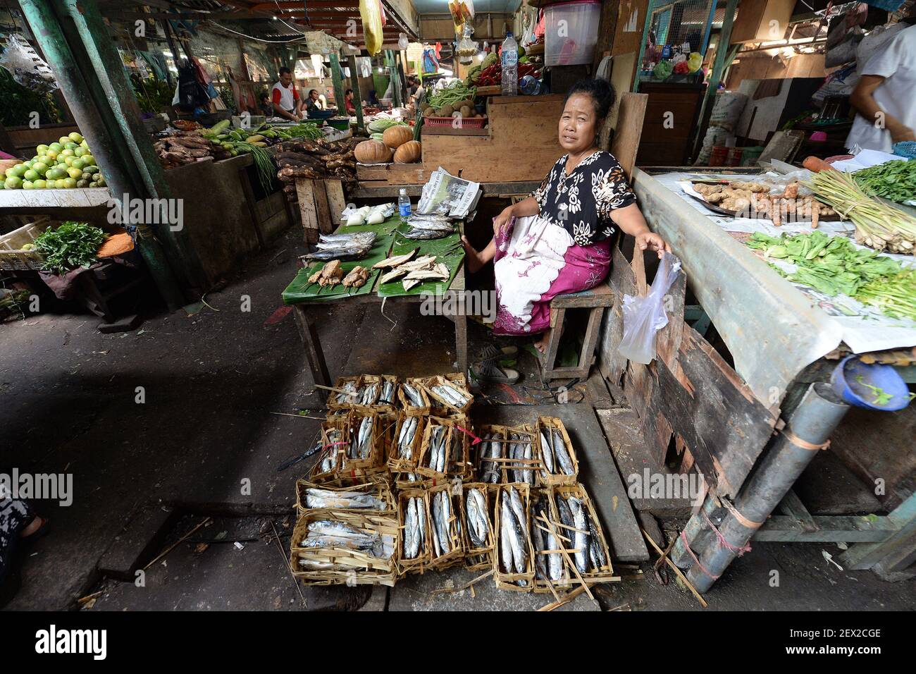 Fish vendor Aziza waits for customers inside the Pucang market in ...
