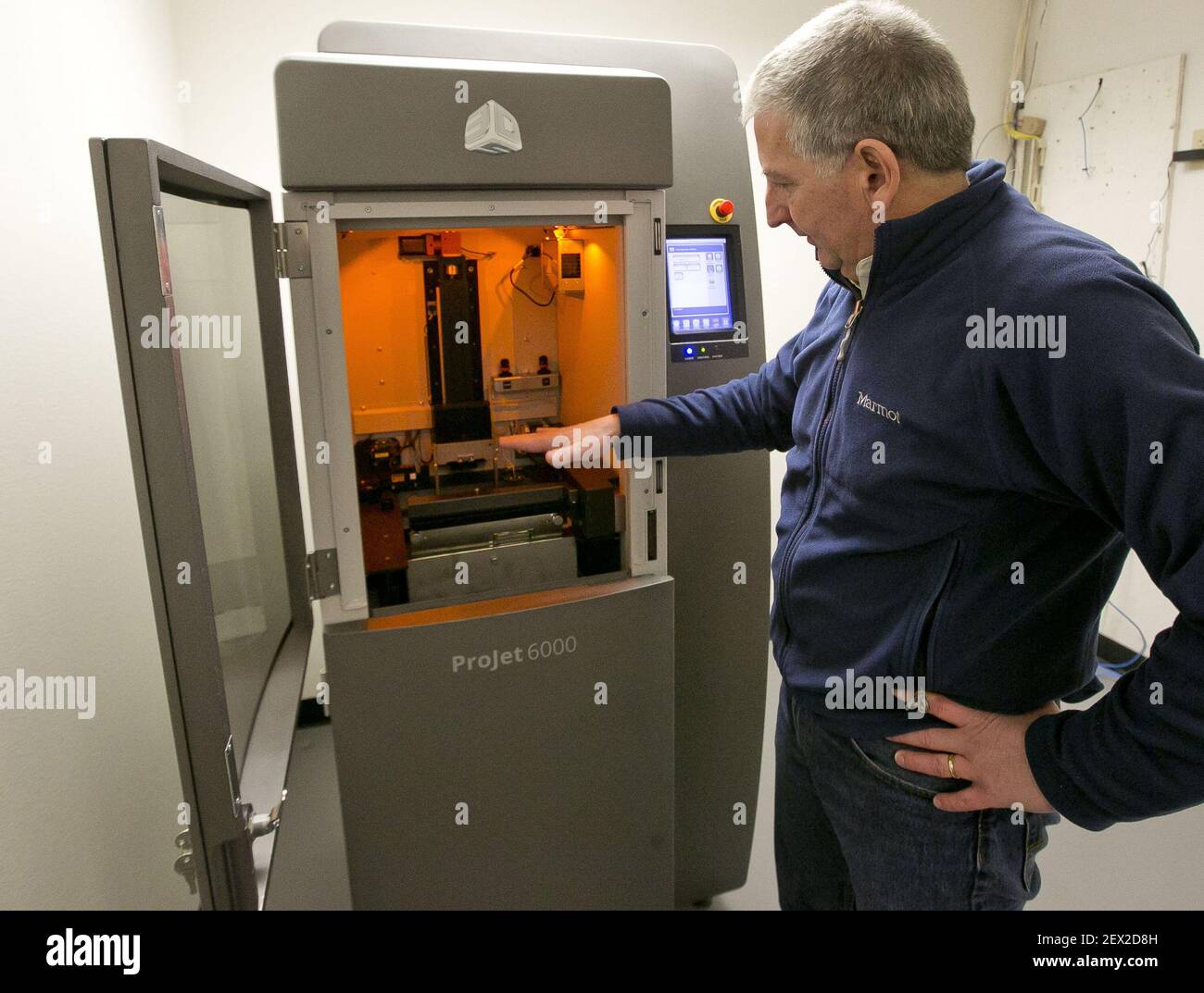 Brian Hoffman prepares a 3D printer for a prototype part that will take ...