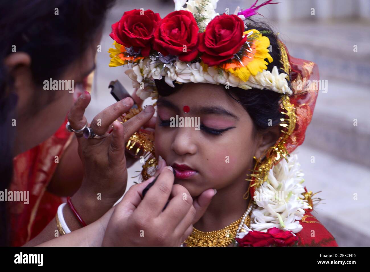 KOLKATA, INDIA - MARCH 28, 2015 - A mother puts makeup on her daughter ...