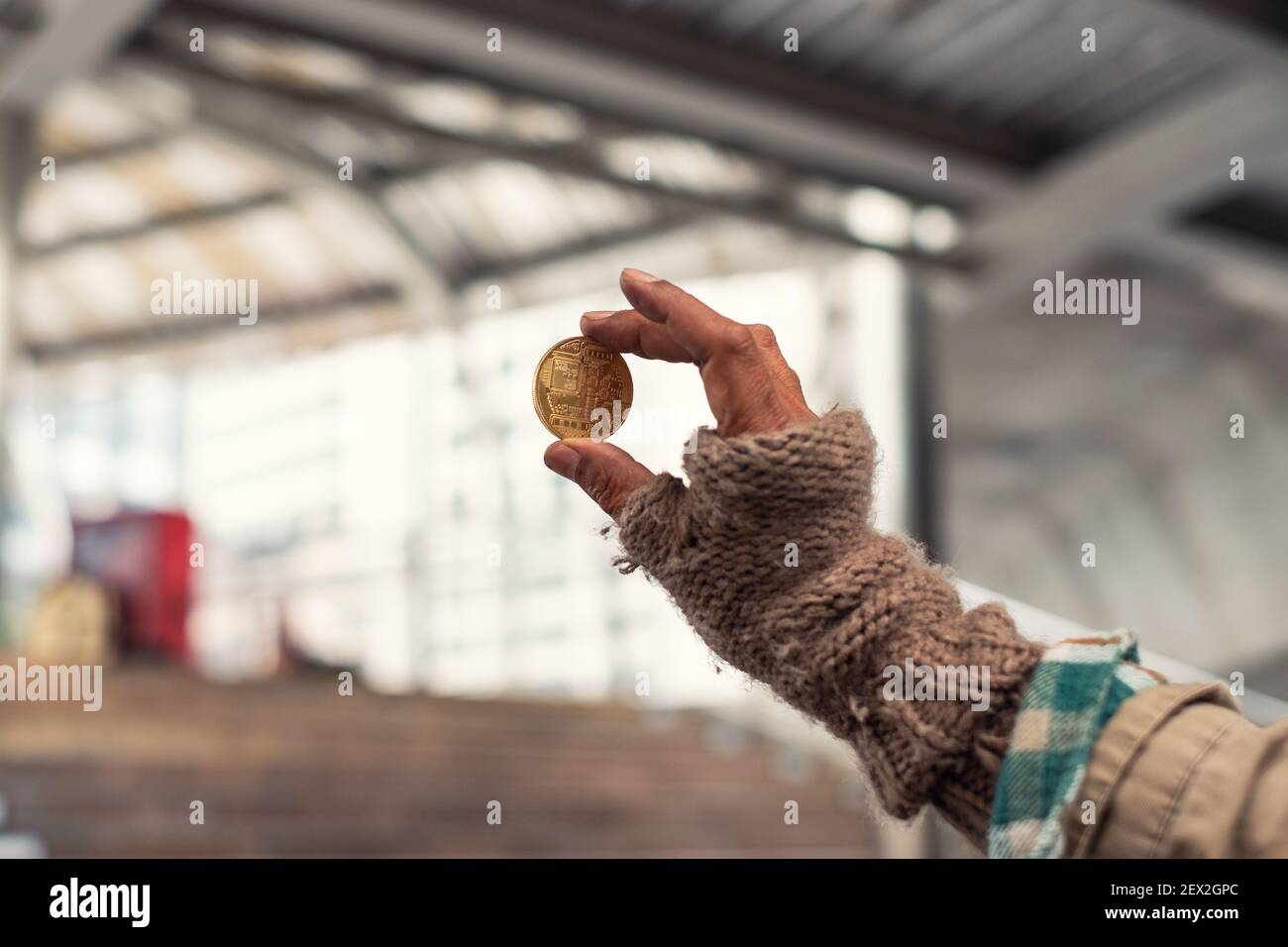 Dirty hand homeless holding gold coin of cryptocurrency Stock Photo - Alamy