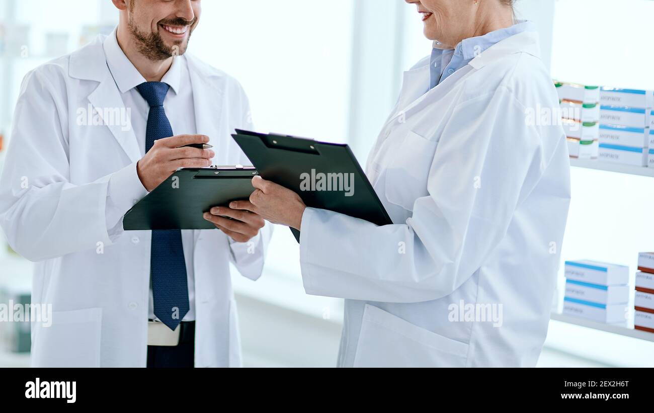two apothecary man and woman talking, discussing medications Stock ...