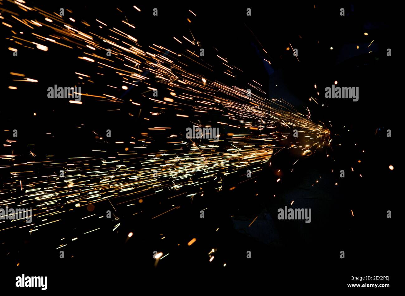 bright sparks of metal against dark background Stock Photo - Alamy