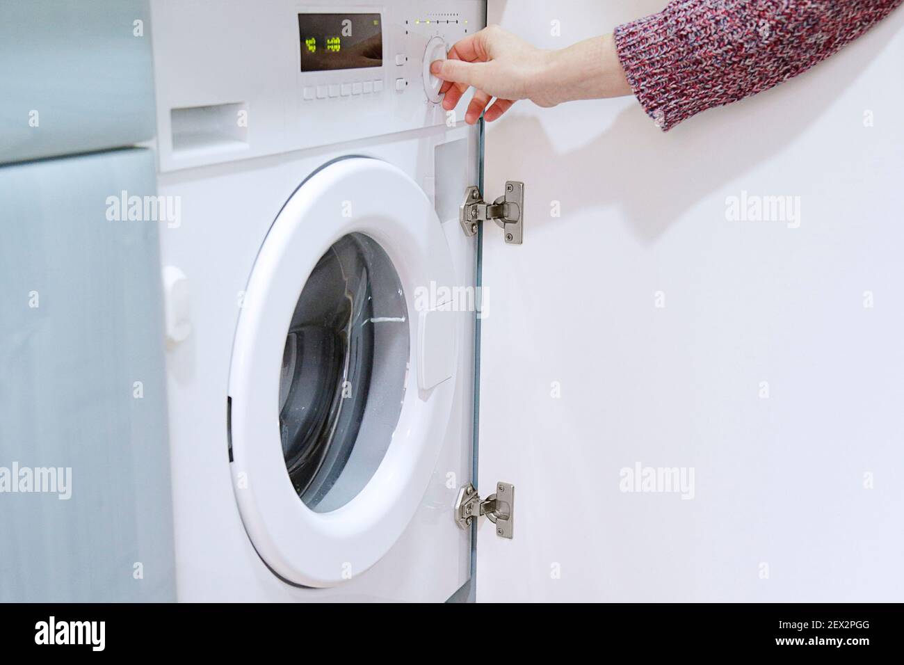 Woman using washing machine hi-res stock photography and images - Alamy