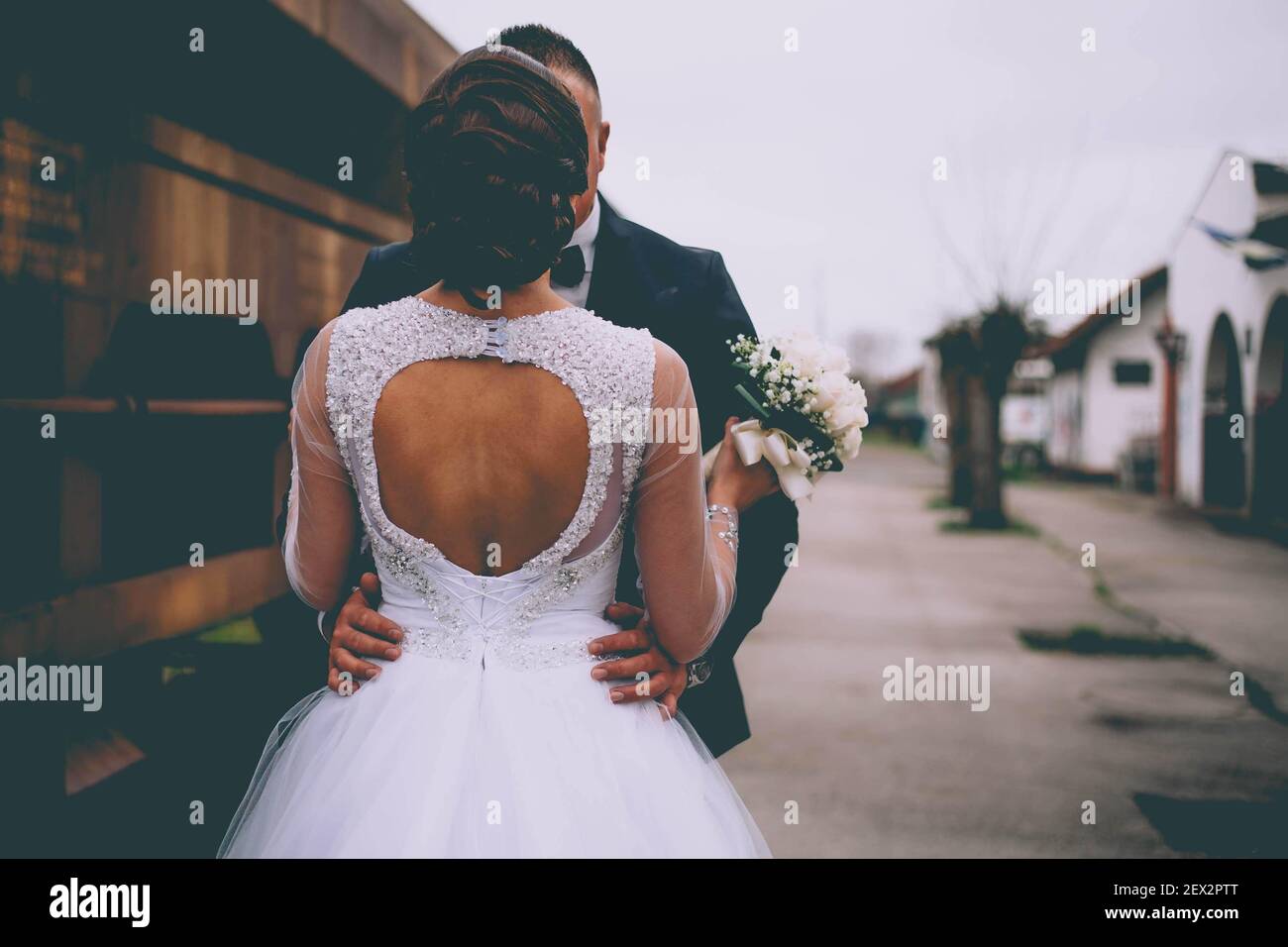 A back view of the bride and the groom hugging Stock Photo - Alamy