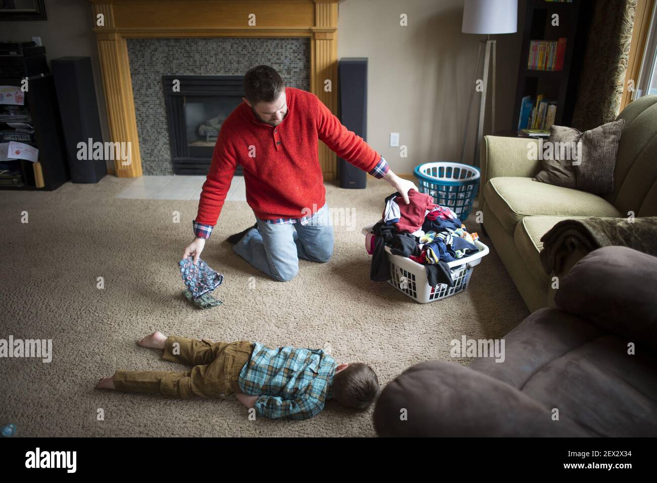 John Drevlow spends part of an afternoon folding his two sons' laundry ...