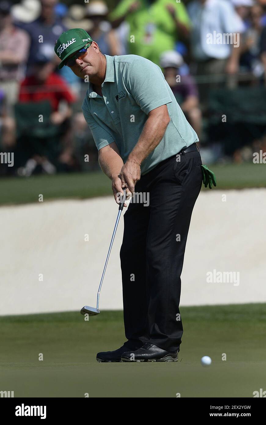 Charley Hoffman follows through on his putt on the 17th green during ...