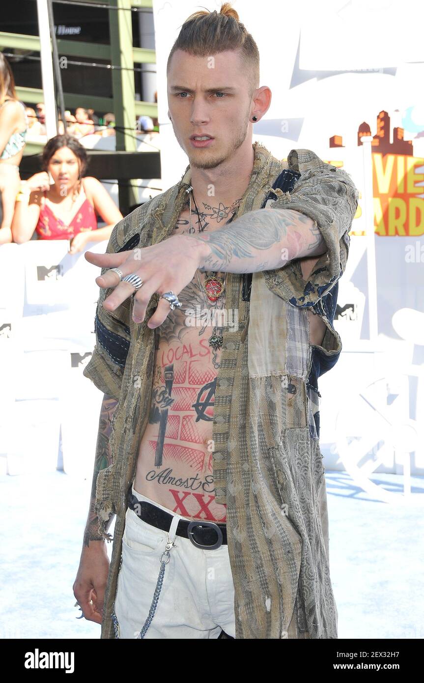 Machine Gun Kelly arrives at the 2015 MTV Movie Awards held at the ...