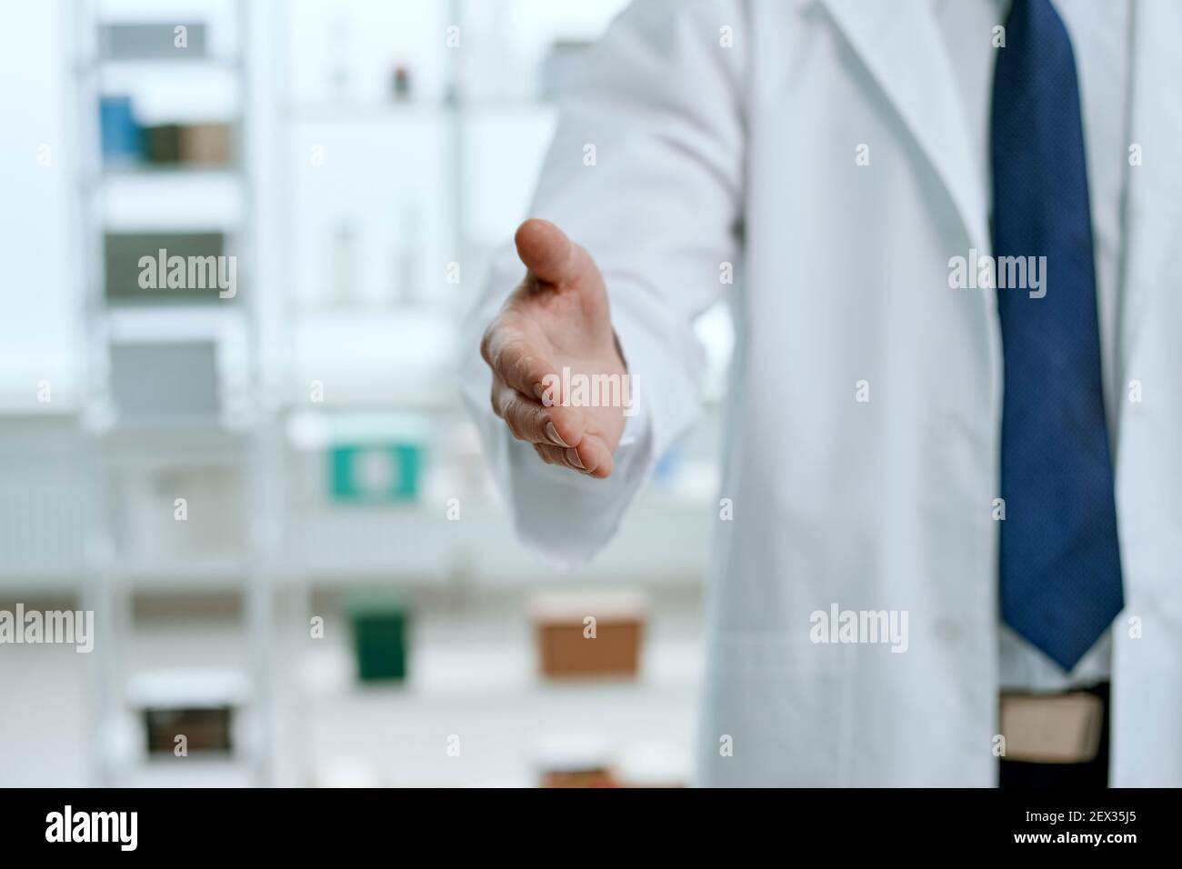 pharmacist consultant with a welcoming handshake . photo with a copy ...