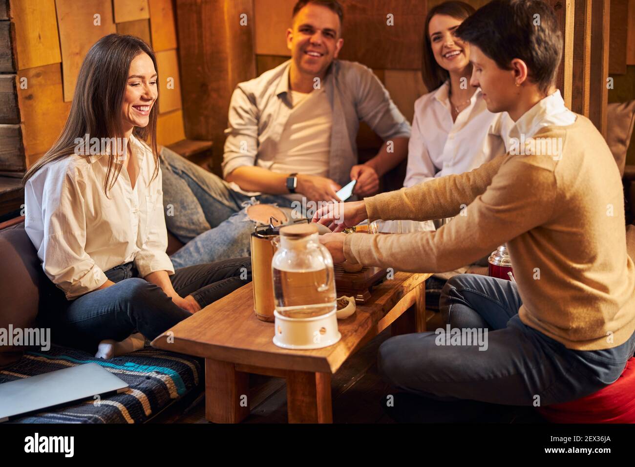 Group of friends drinking tea and smiling in cafe Stock Photo - Alamy