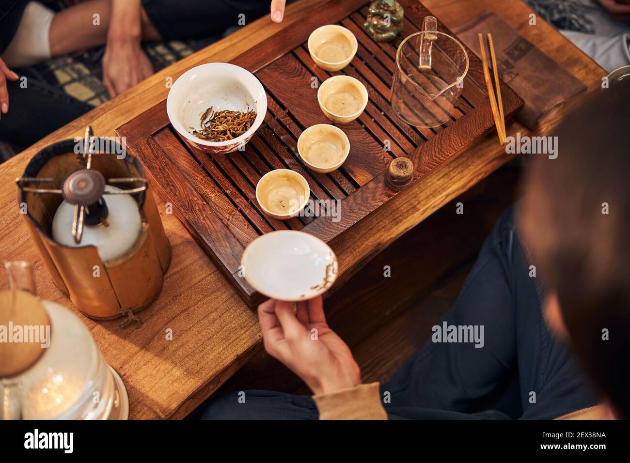 Young man and woman having tea ceremony in cafe Stock Photo - Alamy