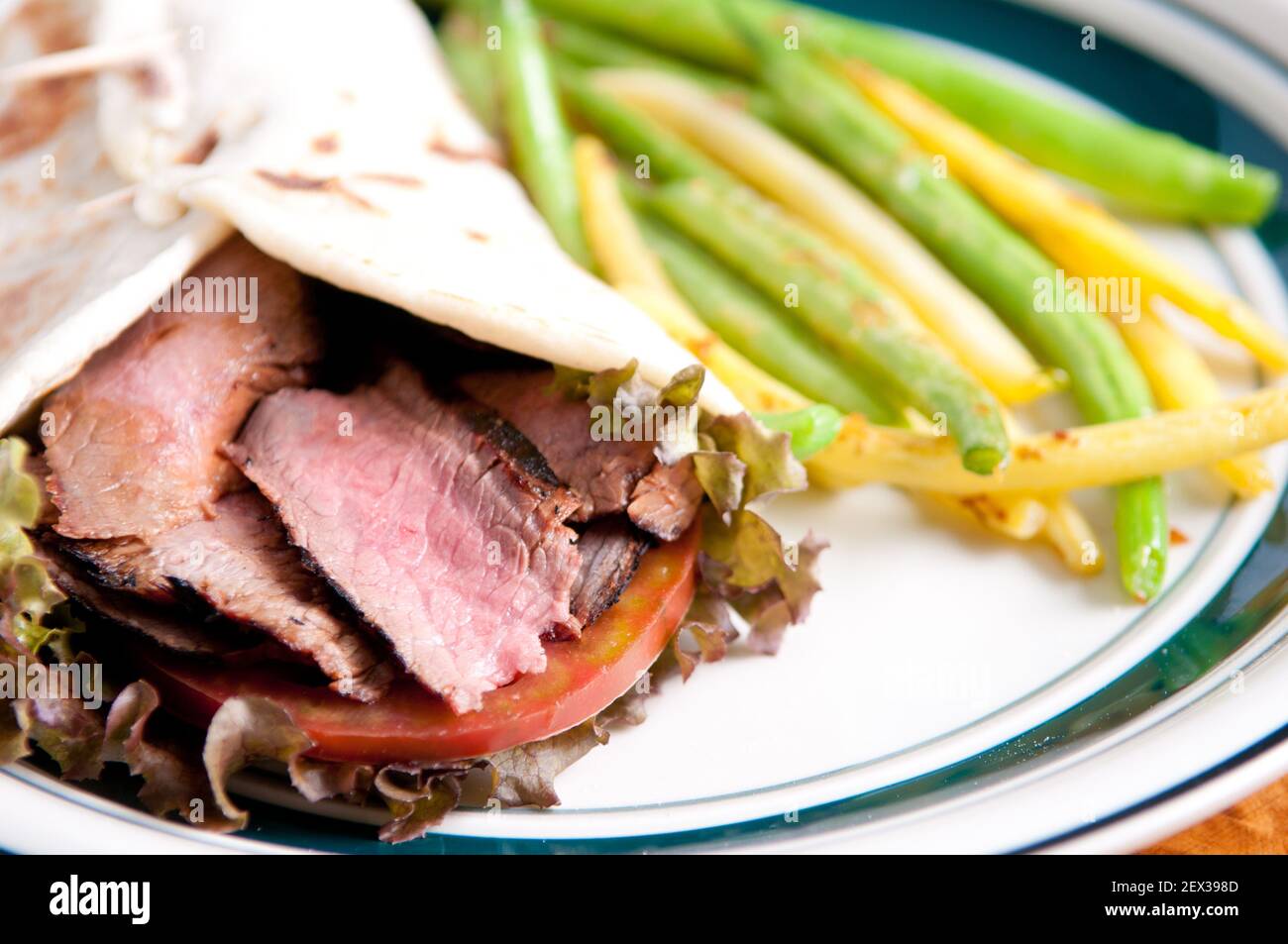 flank steak burrito on home made flatbread with garlic fried string ...
