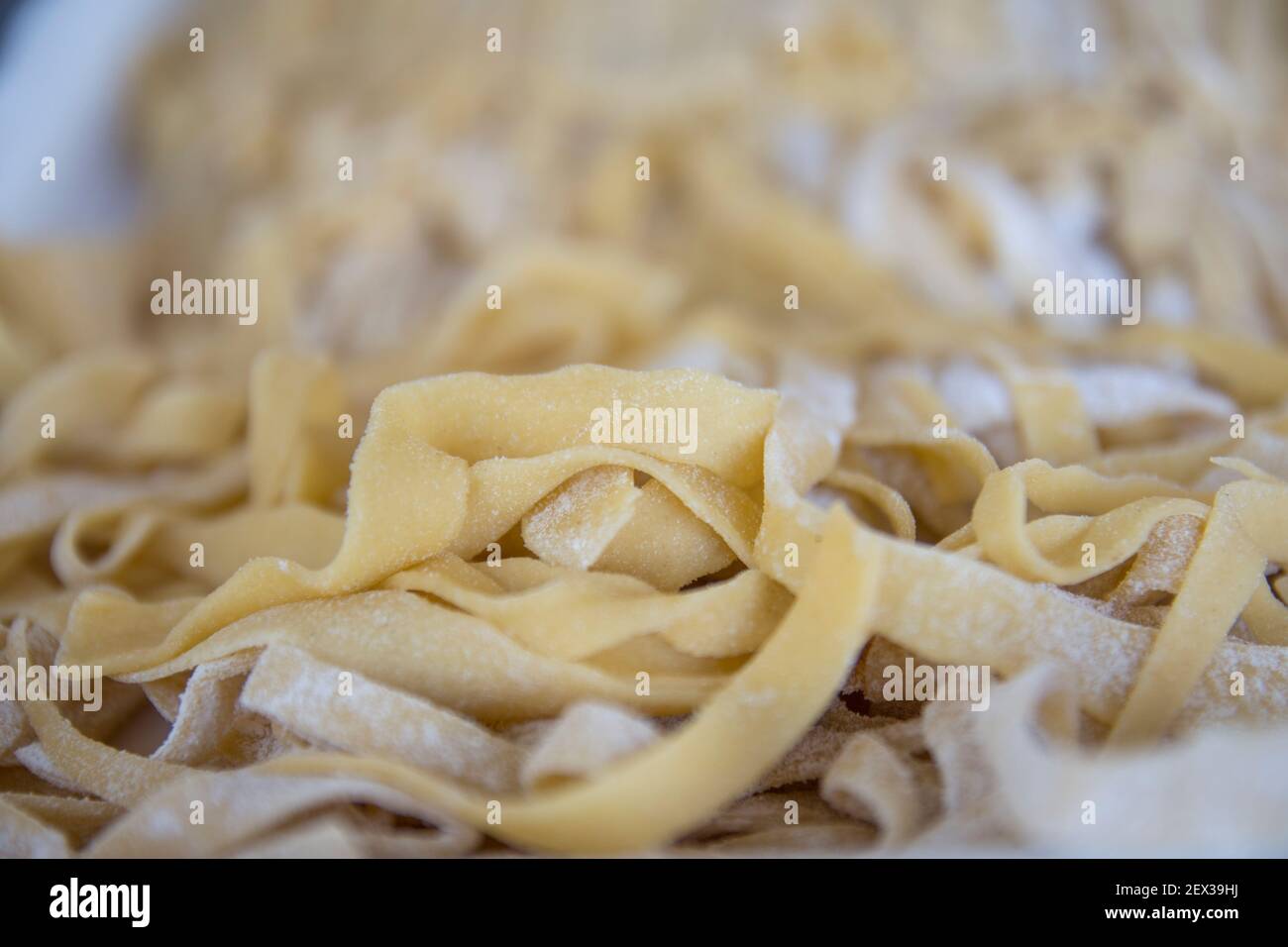 Macro picture of traditional Italian raw pasta Tagliatelle, selective ...