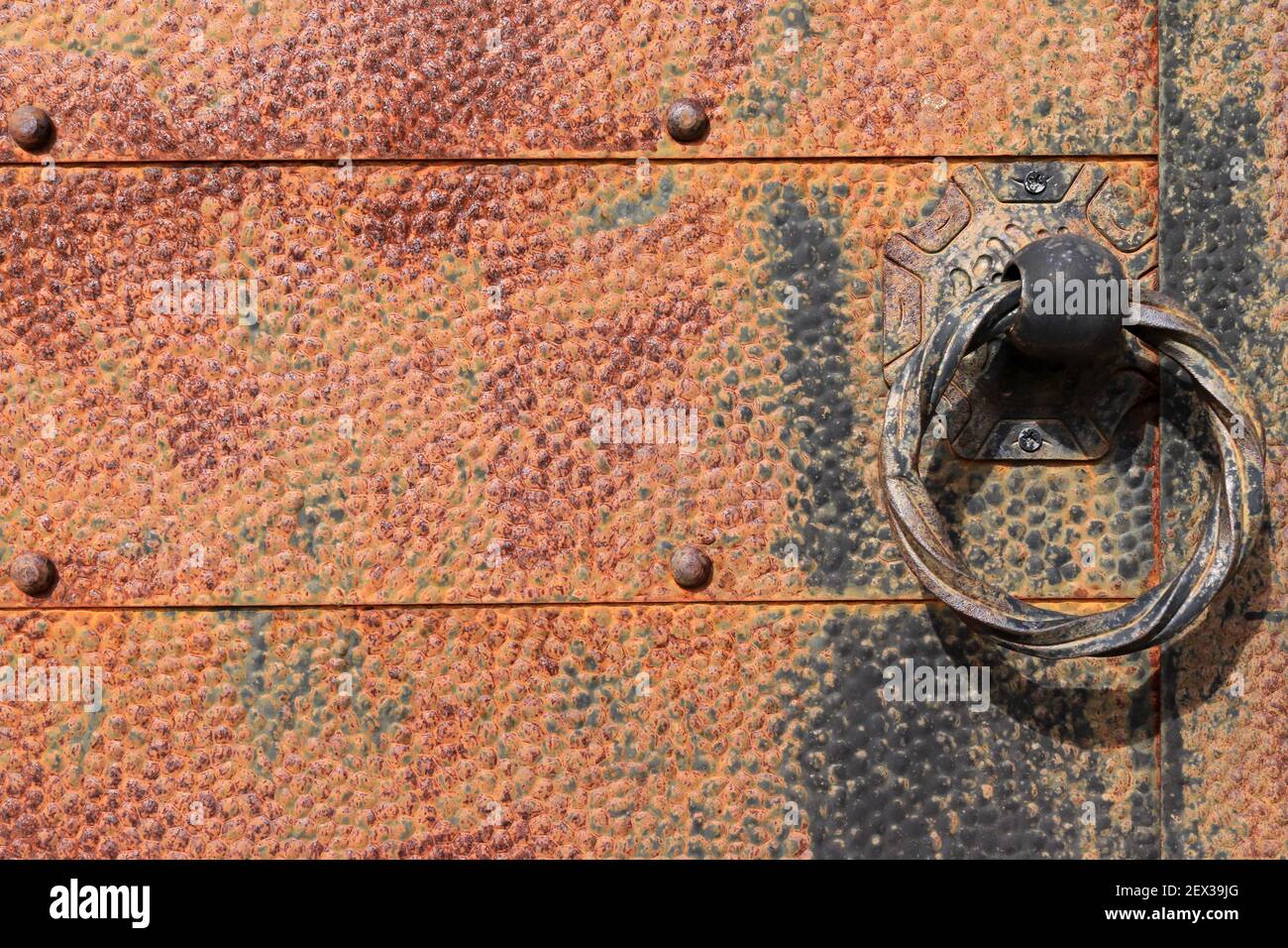 Old riveted iron door.Metal handles Stock Photo - Alamy