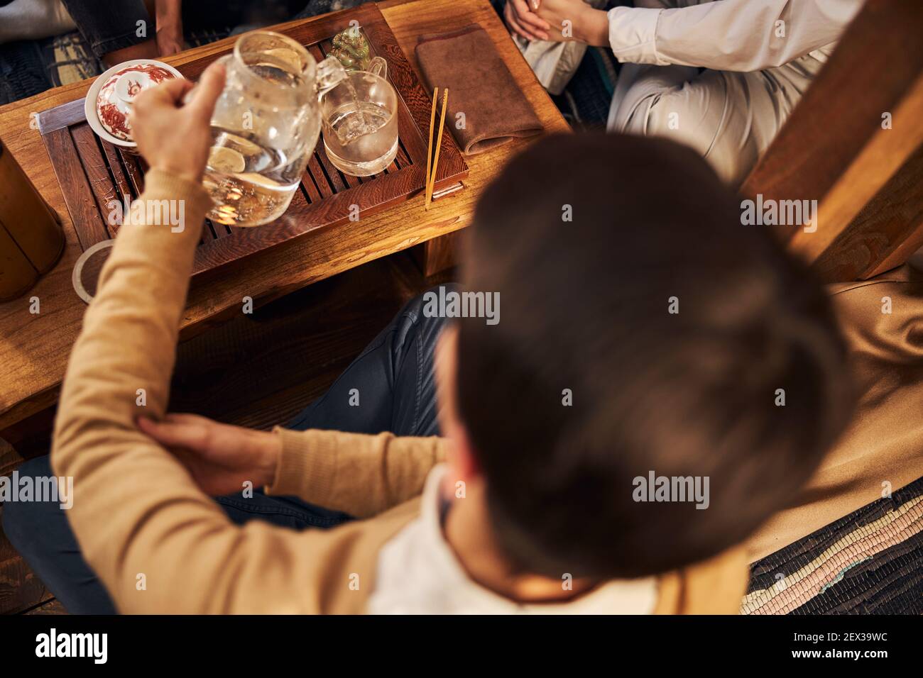 Young man performing traditional tea ceremony in cafe Stock Photo - Alamy