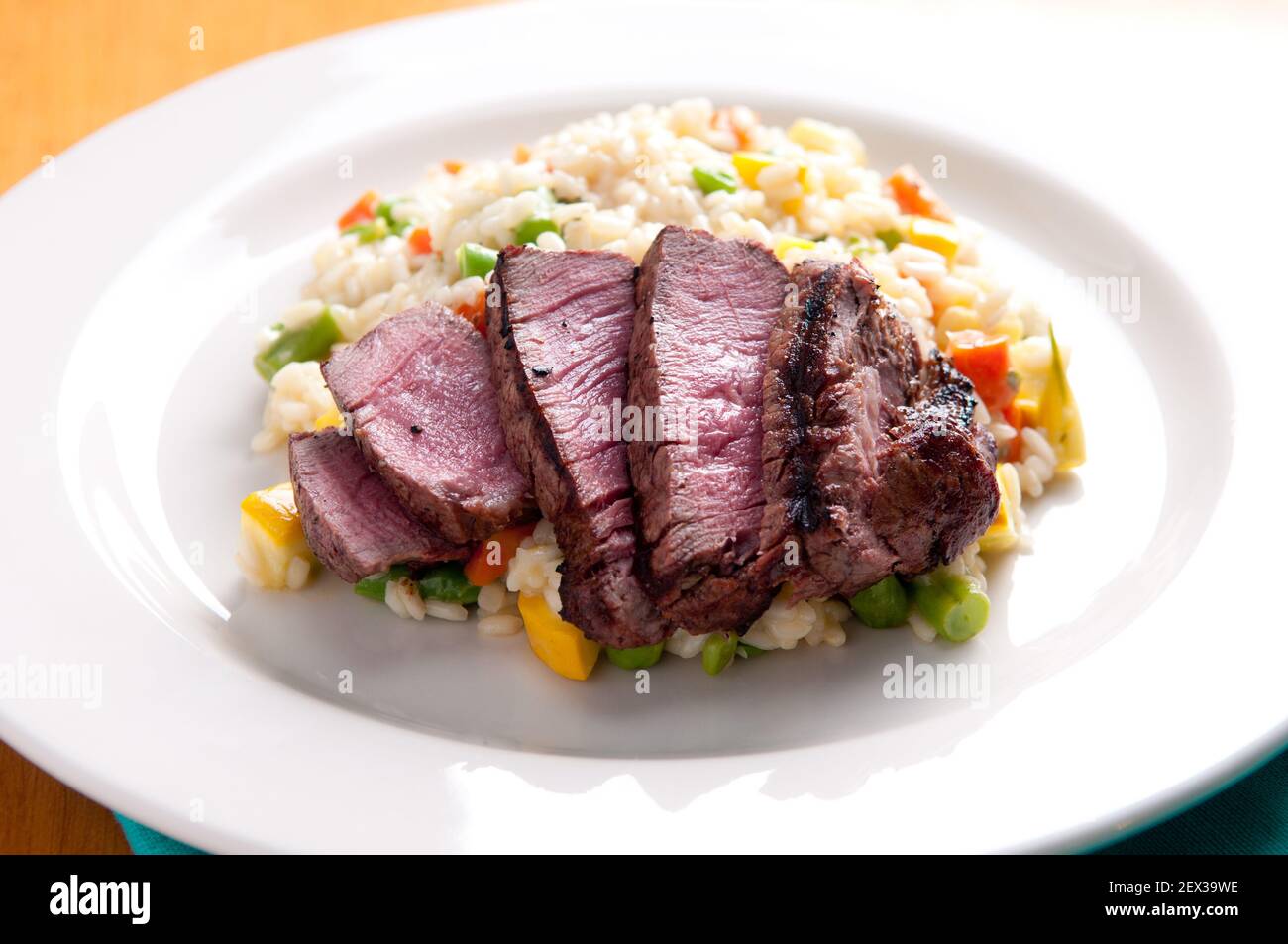 vegetable risotto with rare beef tenderloin grilled to perfection and ...